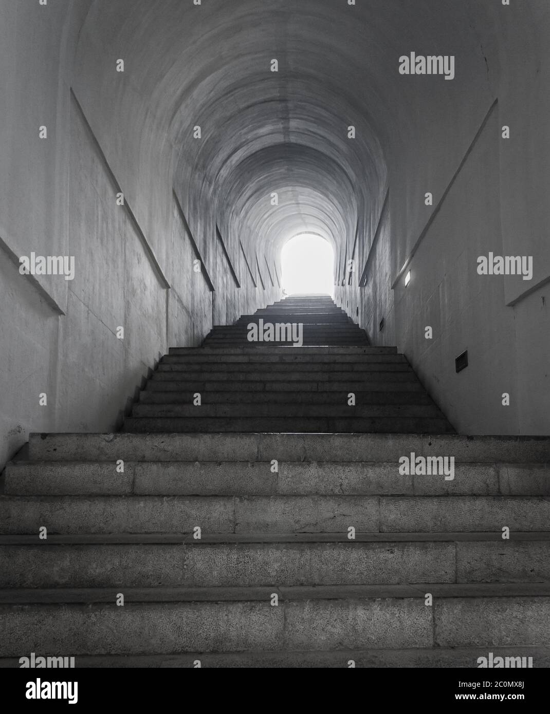 Light at the end of tunnel with ascending stairs Stock Photo - Alamy
