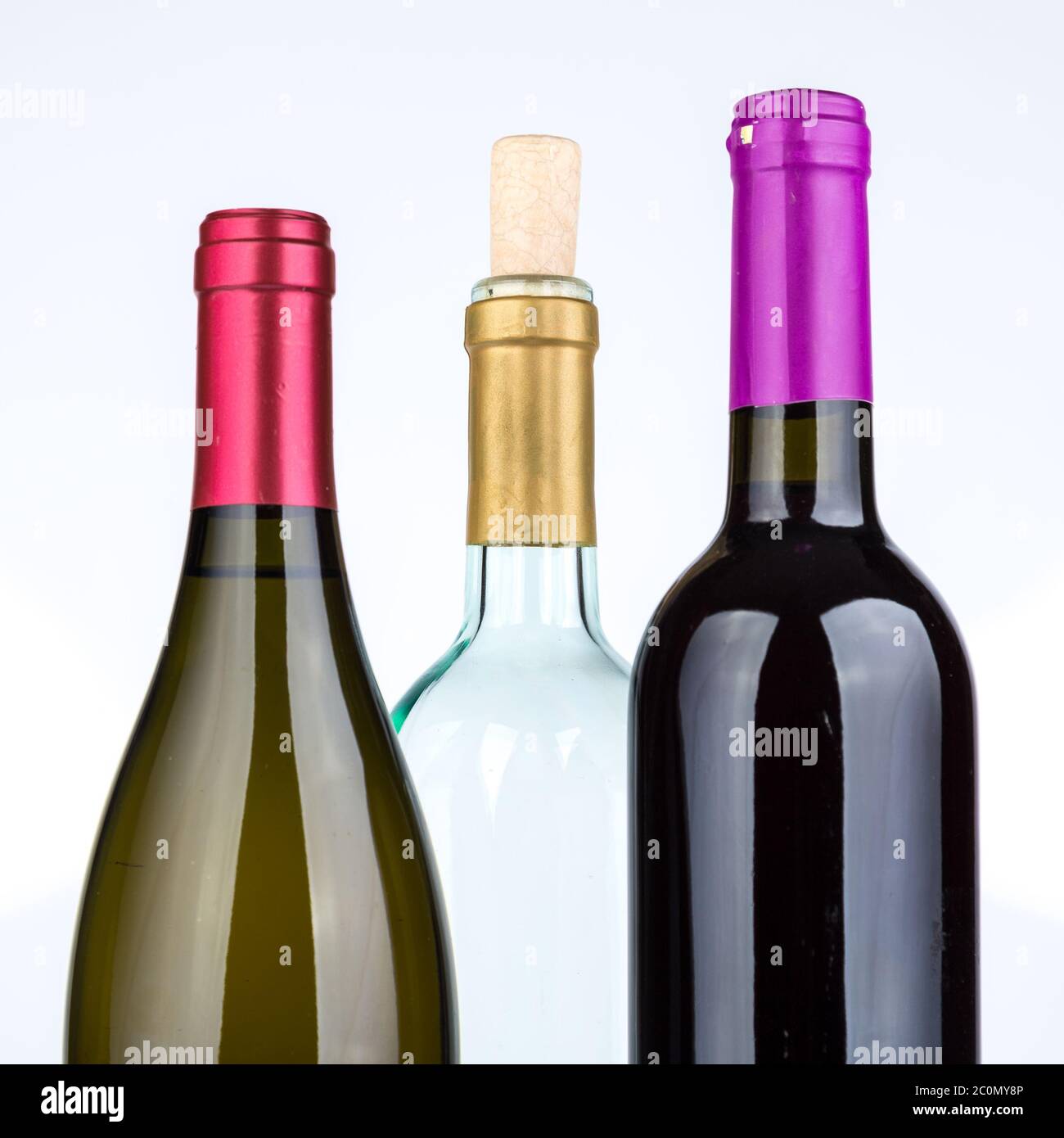 Three wine bottles isolated on white background Stock Photo - Alamy