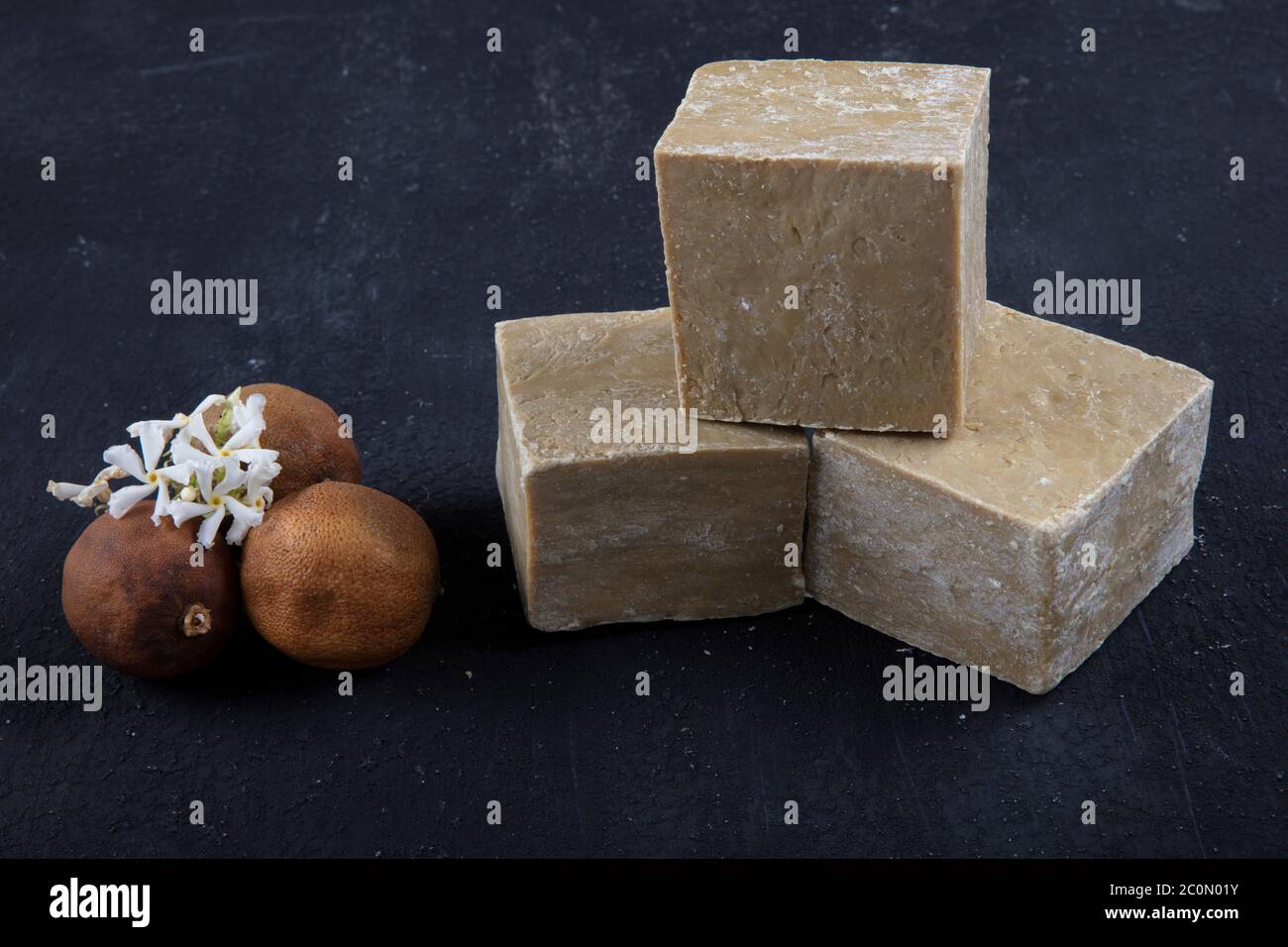 Natural handmade soap and bay leaves (laurel) on black wood background ...