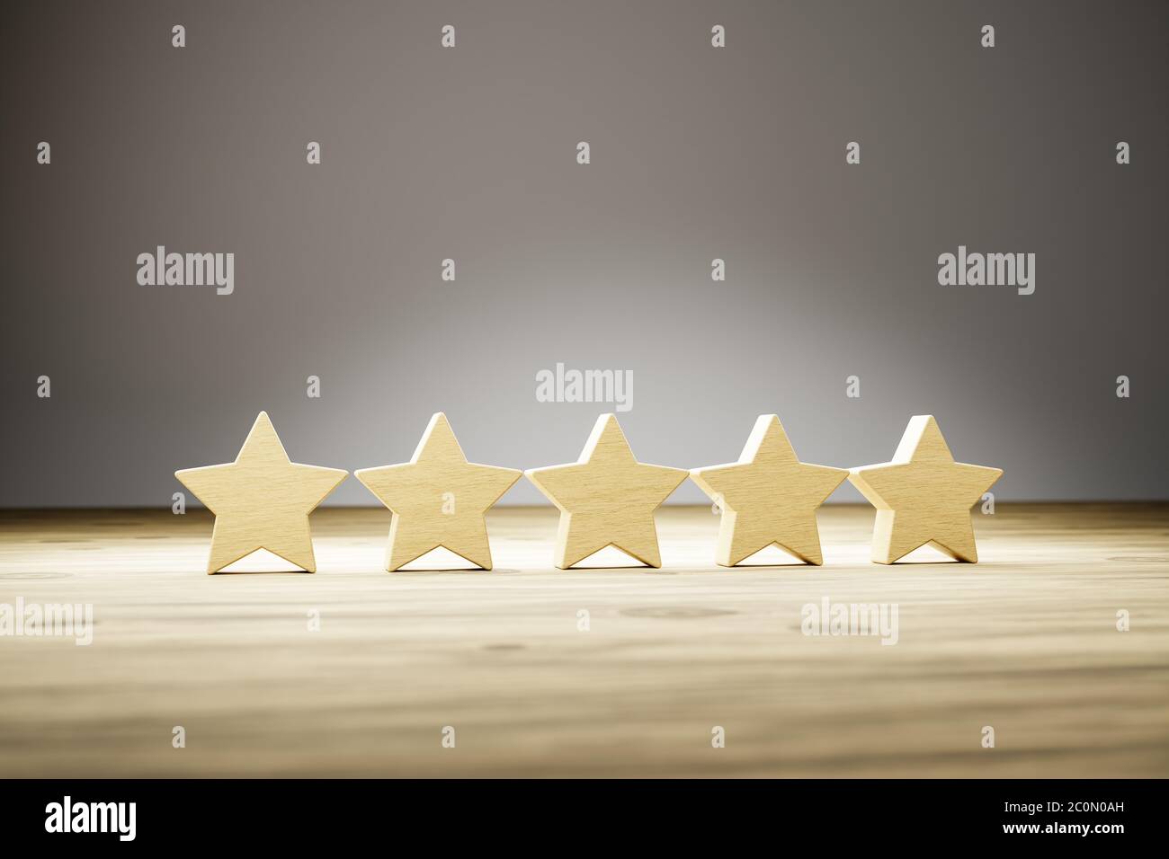 Five star rating: five wooden stars in a row on a wooden table with ...