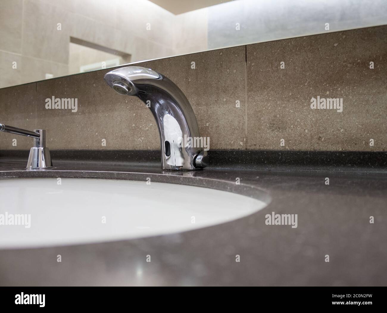Faucet modern in restroom Stock Photo - Alamy