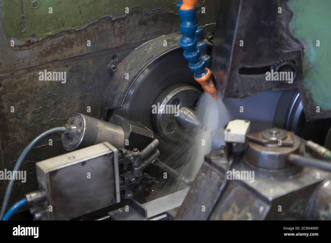 Detail of a water cooled industrial machinery grinding metal components ...