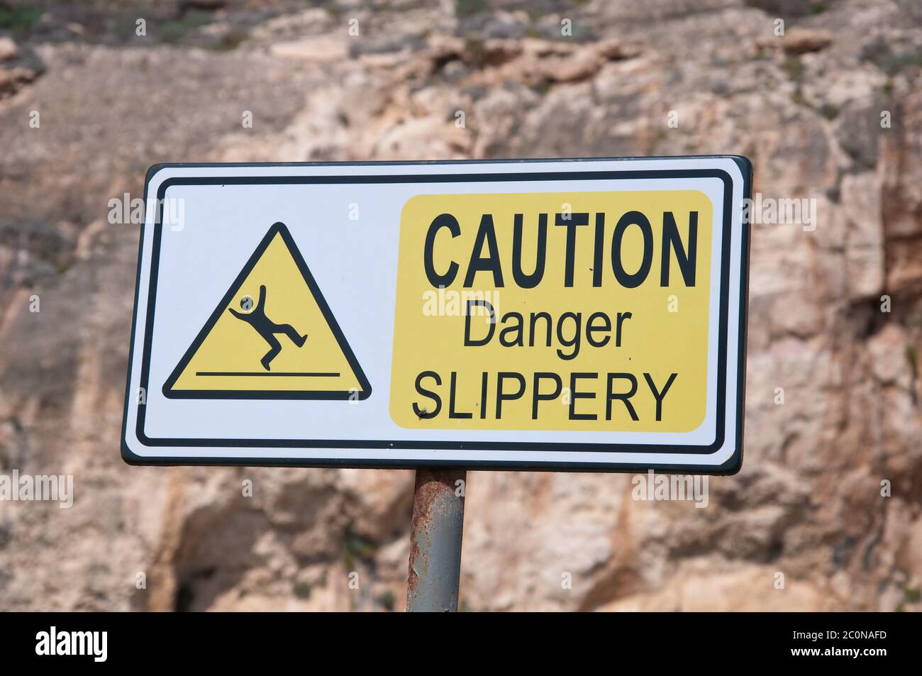Sign indicating attention danger of slipping Stock Photo - Alamy