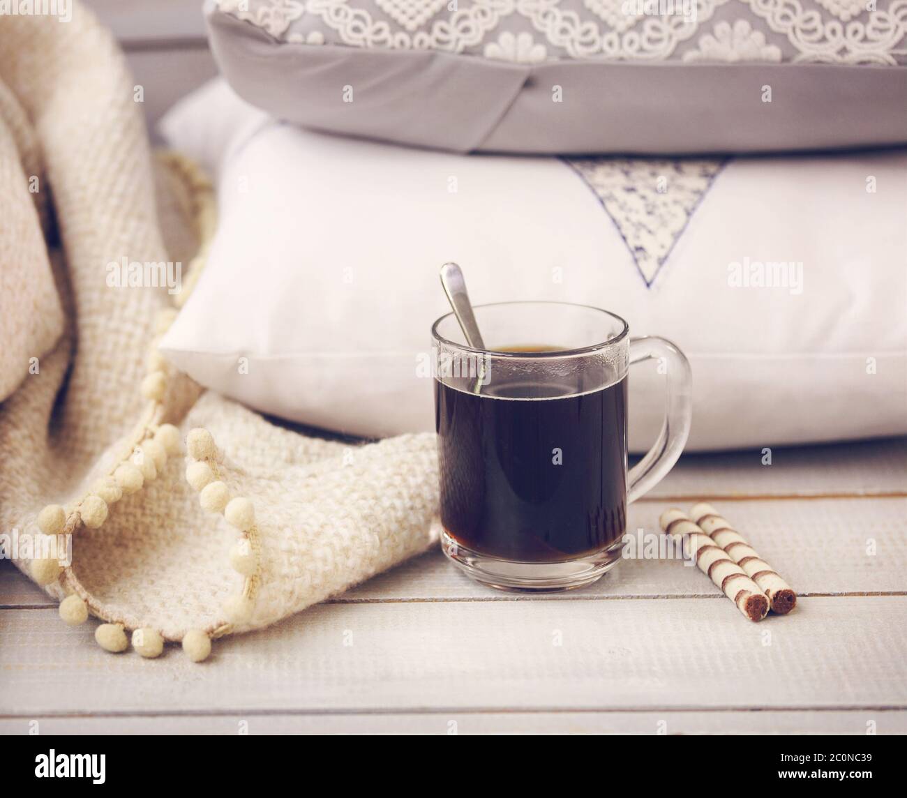 Cozy still life with coffee, pillows and plaid Stock Photo - Alamy