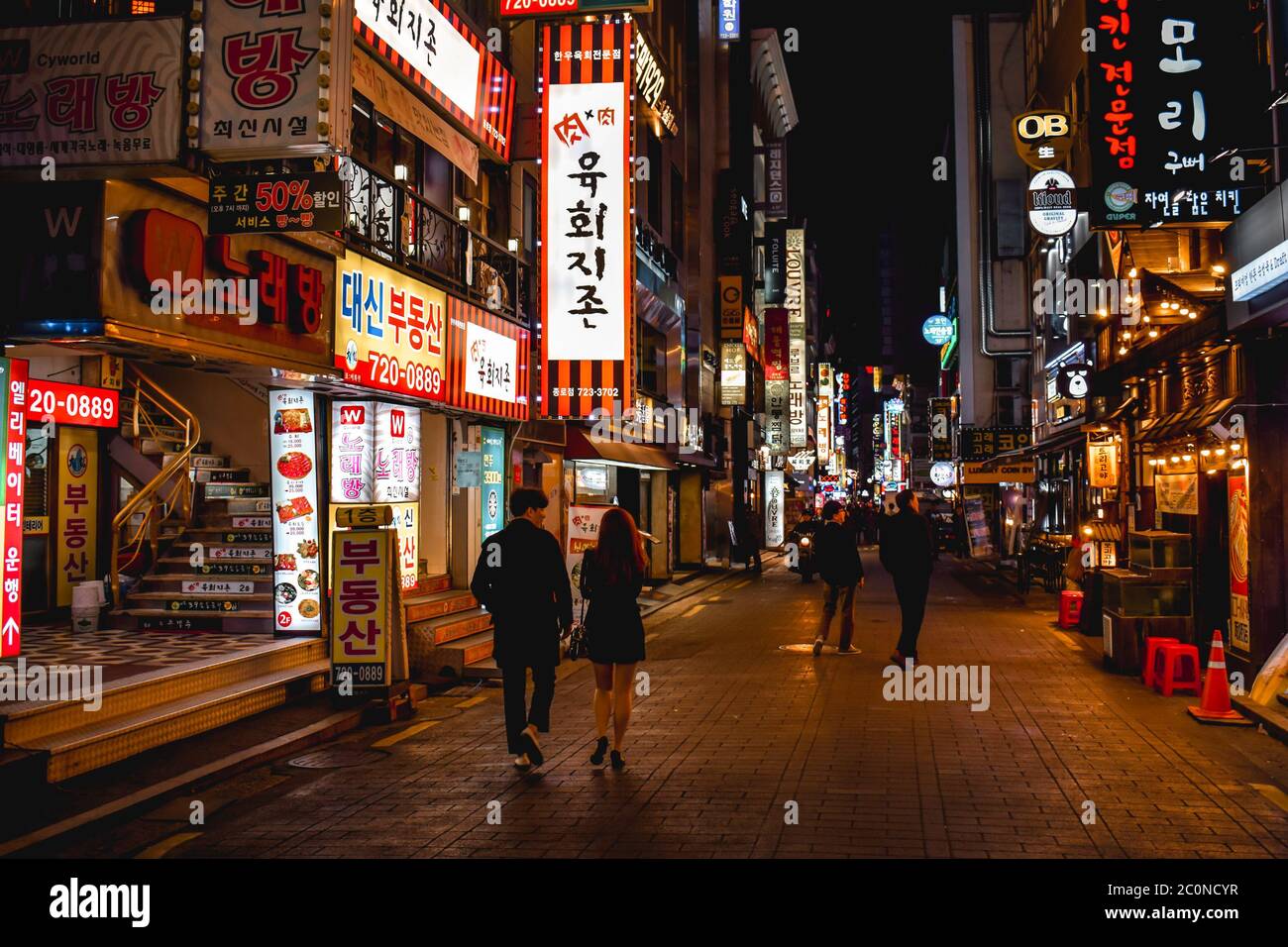 Couple walking in the neon light district in Myeongdong Seoul Korea ...