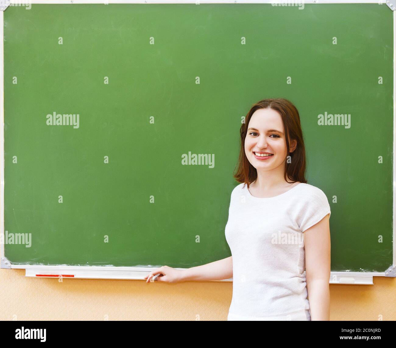 Student girl standing near clean blackboard in the classroom Stock ...