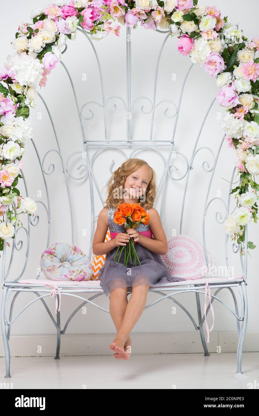 pretty teen girl sitting with flowers Stock Photo - Alamy