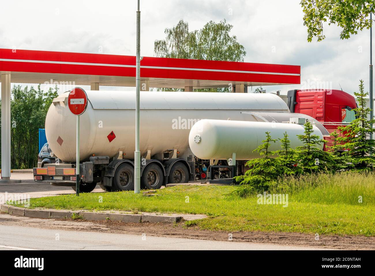 Tanker gas truck delivering fuel at service station Stock Photo - Alamy