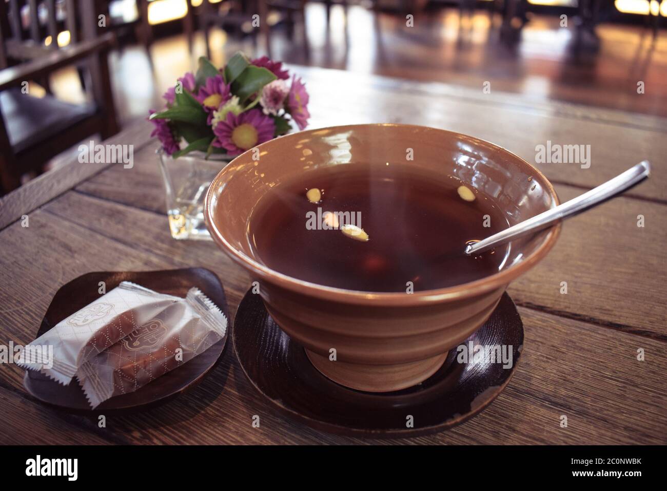 Traditional Korean tea with pine nuts and cookies on a table with ...