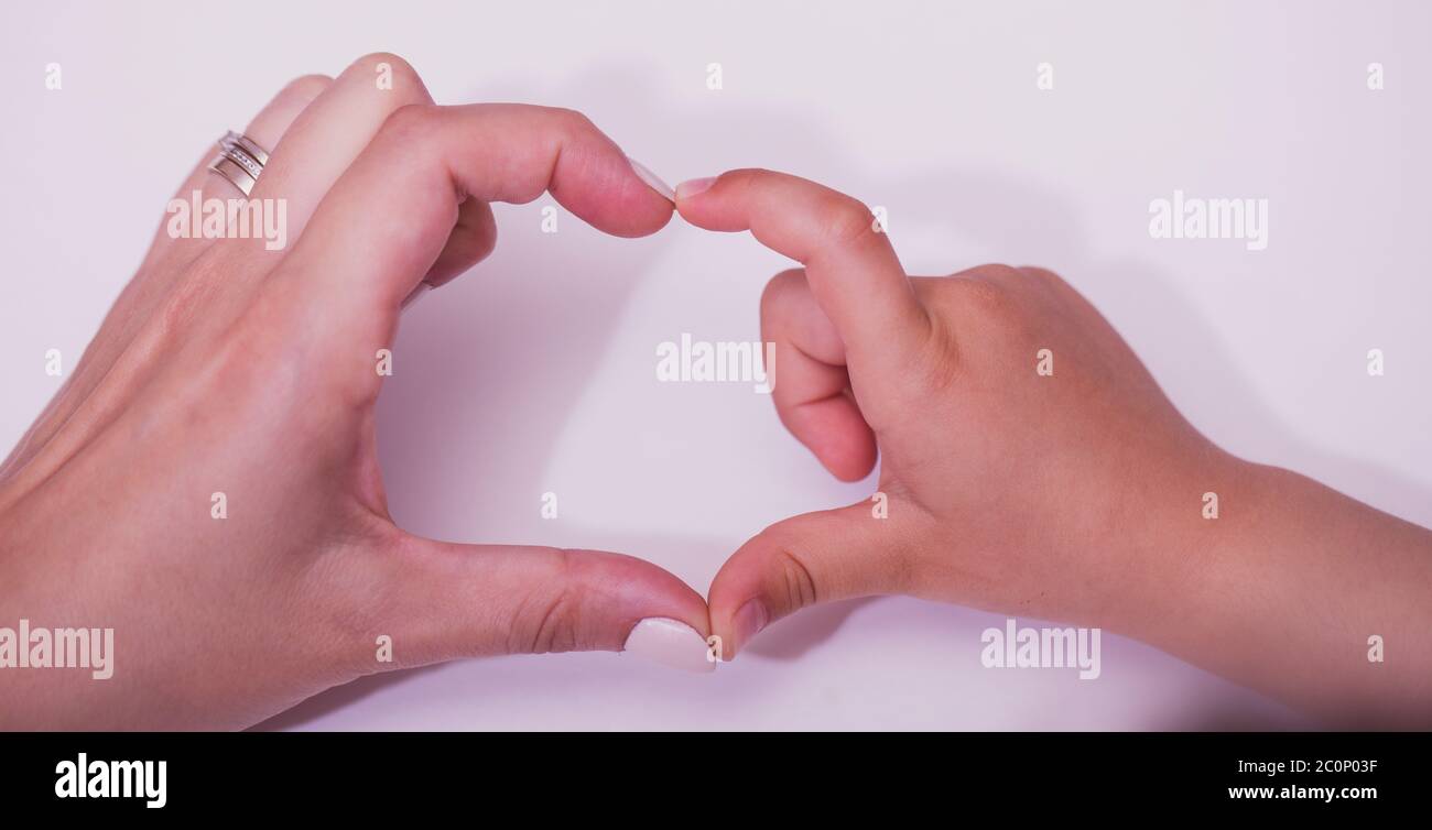 Love heart in hand. Hand of mother and child making heart shape ...
