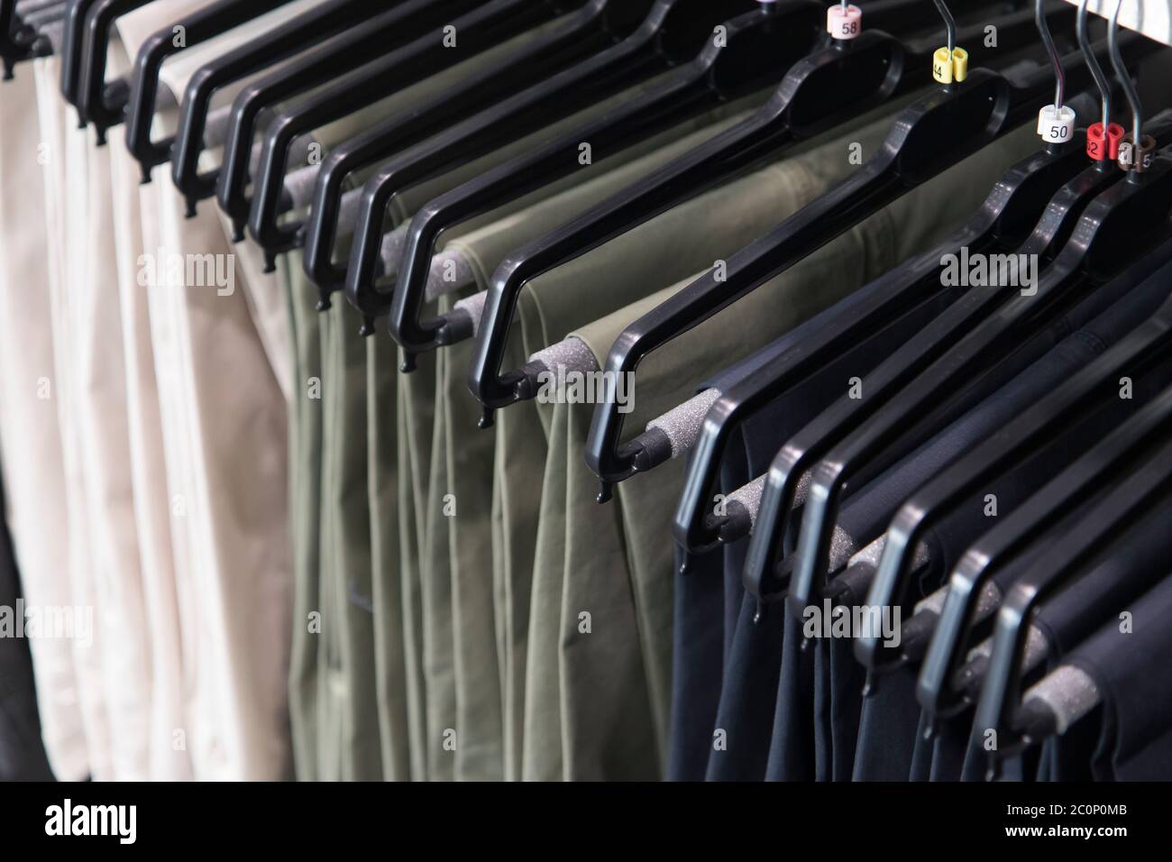 Close up on hanging pants on a rack, for a retail concept image Stock ...