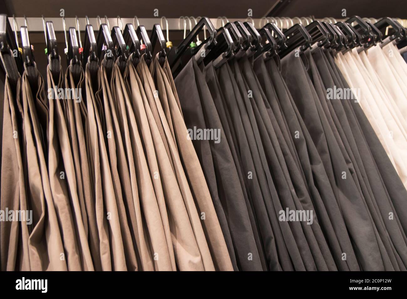 Close up on hanging pants on a rack, for a retail concept image Stock ...