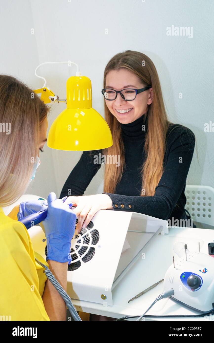 Nail care. Manicure in the salon. The master manicures the girl, beauty ...