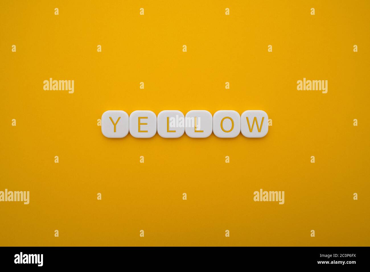Alphabet YELLOW word block with YELLOW background Stock Photo - Alamy
