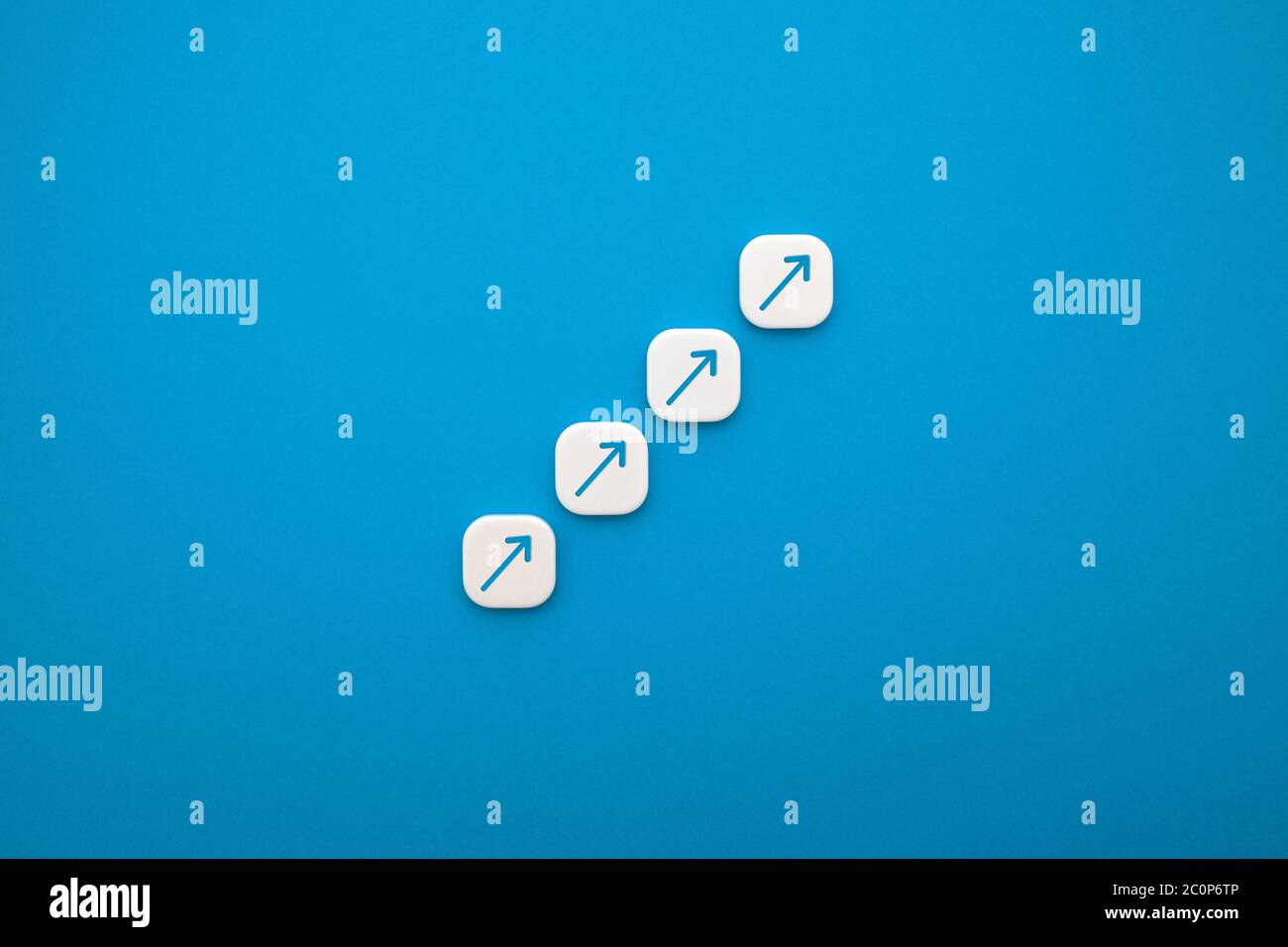 Blue Arrow Block Gradually Raising from Blue Background Stock Photo - Alamy