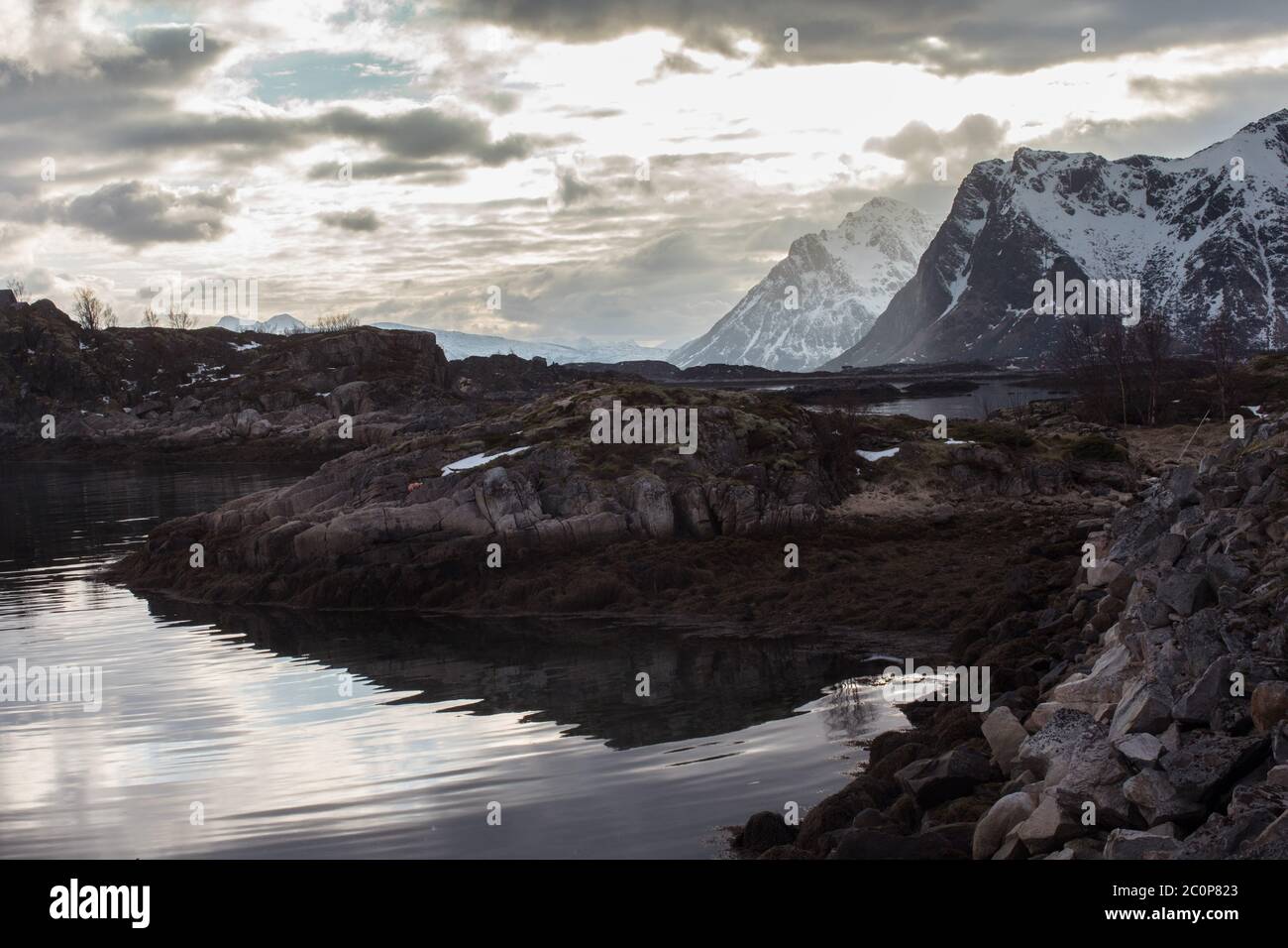 A mountain reflection on a fjord at dusk Stock Photo - Alamy