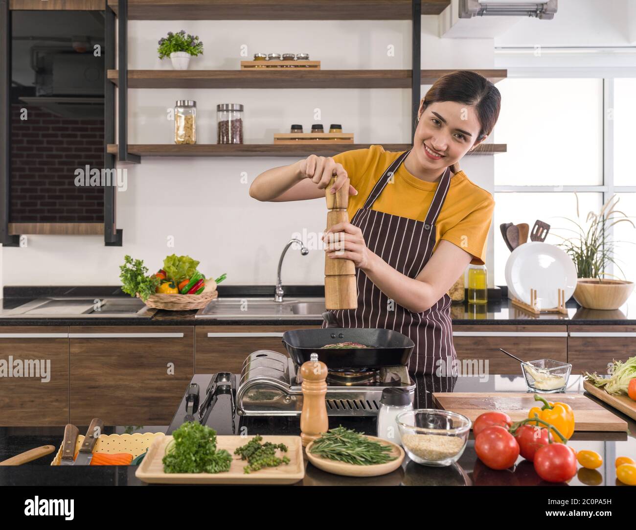 Woman cooking on gas stove in her kitchen hi-res stock photography and ...
