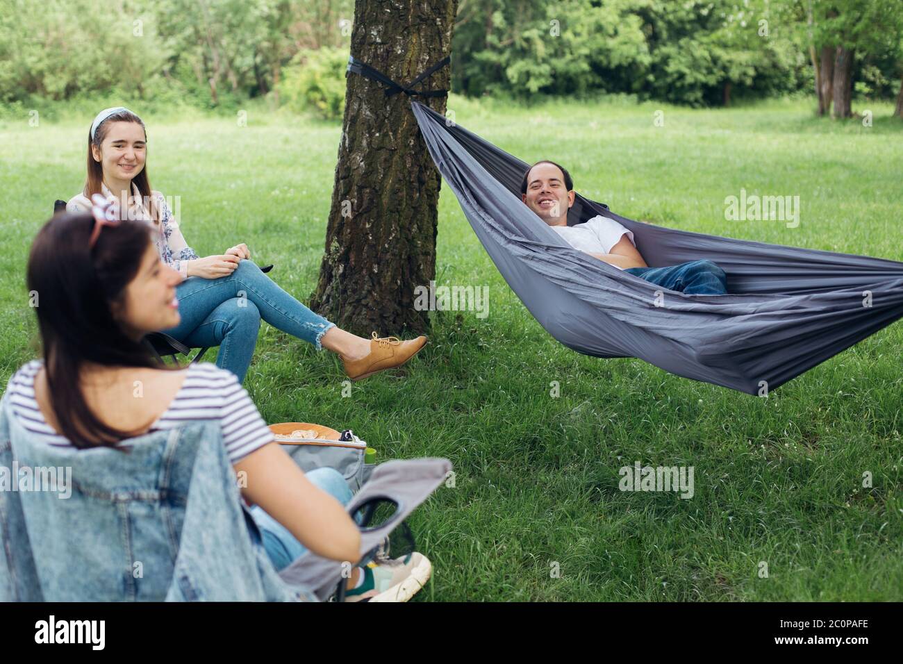 Social distancing. Small group of people enjoying conversation at ...