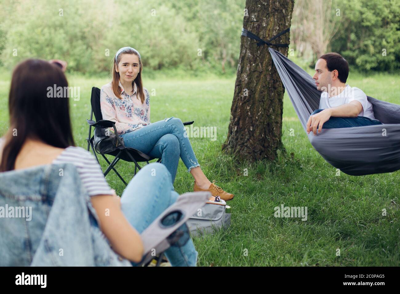 Social distancing. Small group of people enjoying conversation at ...
