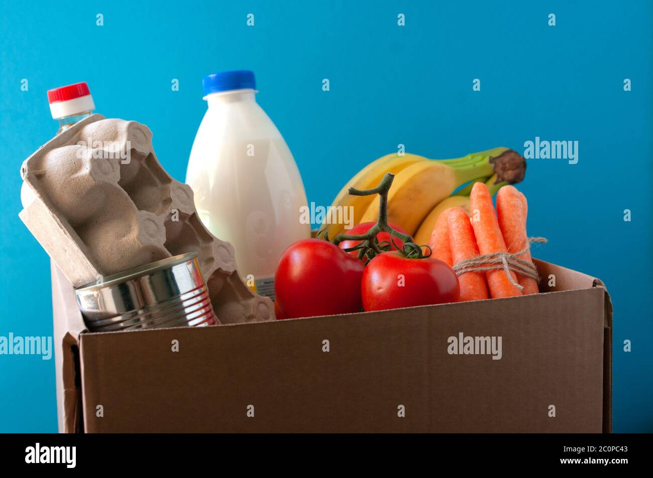 Food delivery. cardboard box with grocery. tomatoes,bananas,milk,eggs ...