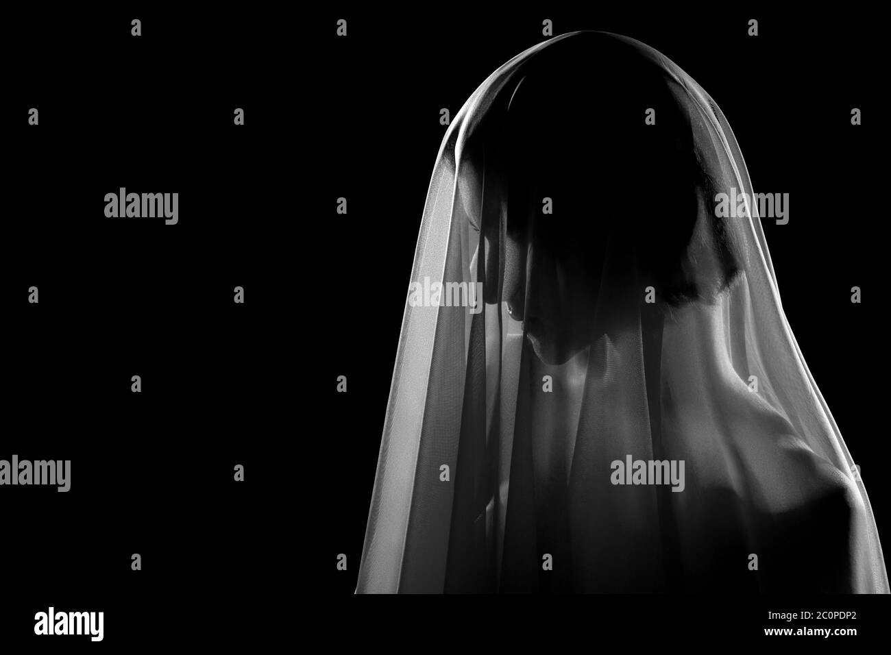 woman under white veil posing sensually on black background with copy ...