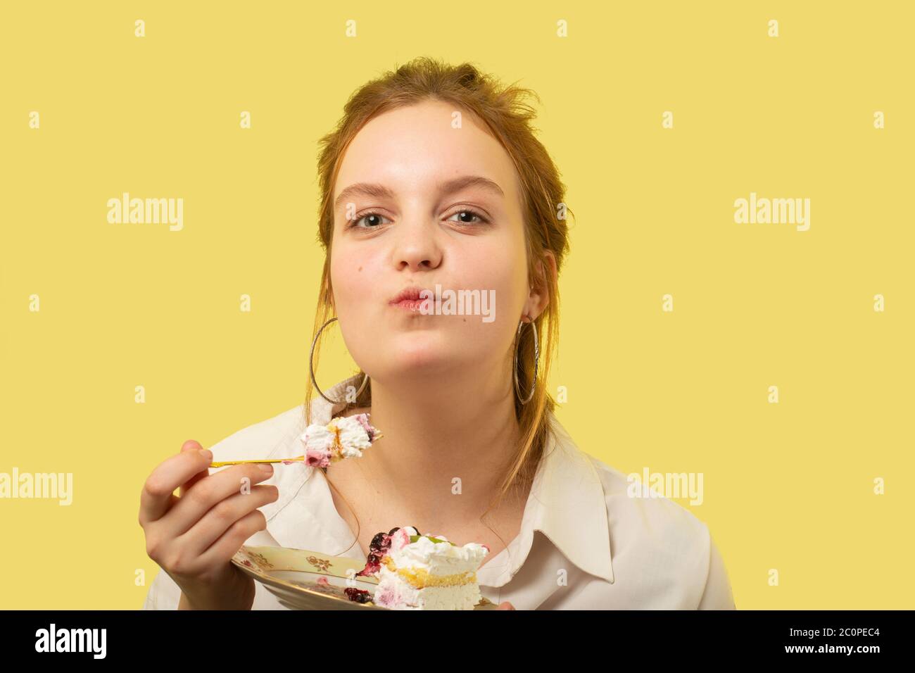fun pretty curly red hair girl with sweet dessert on yellow background ...
