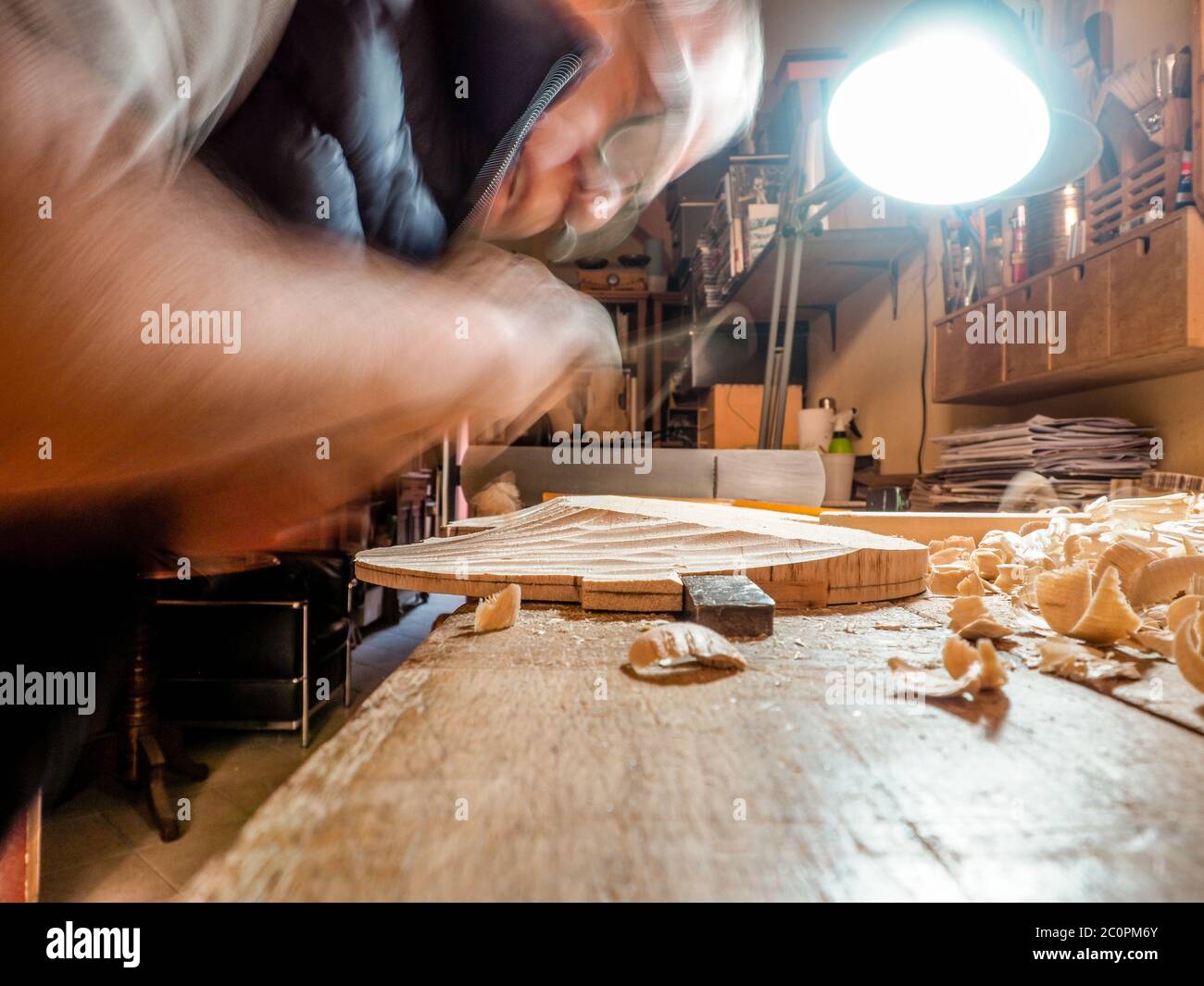 Professional luthier violinmaker artisan working on making a handmade ...