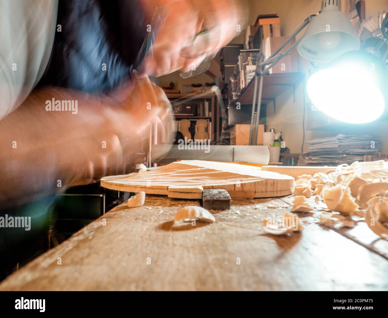Professional luthier violinmaker artisan working on making a handmade ...