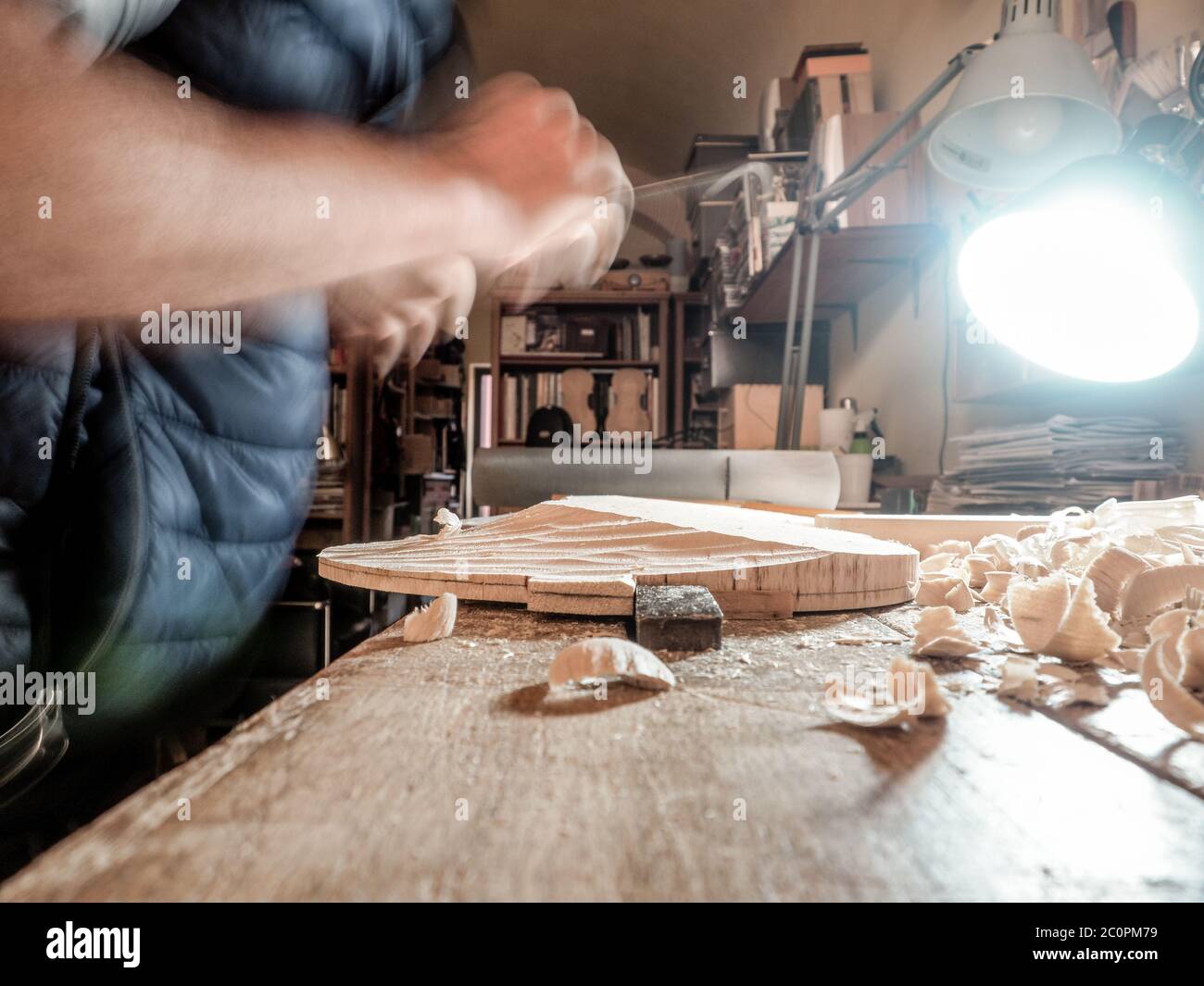 Professional luthier violinmaker artisan working on making a handmade ...