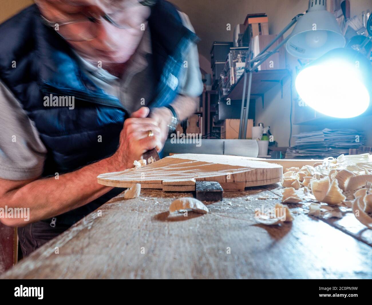 Professional luthier violinmaker artisan working on making a handmade ...