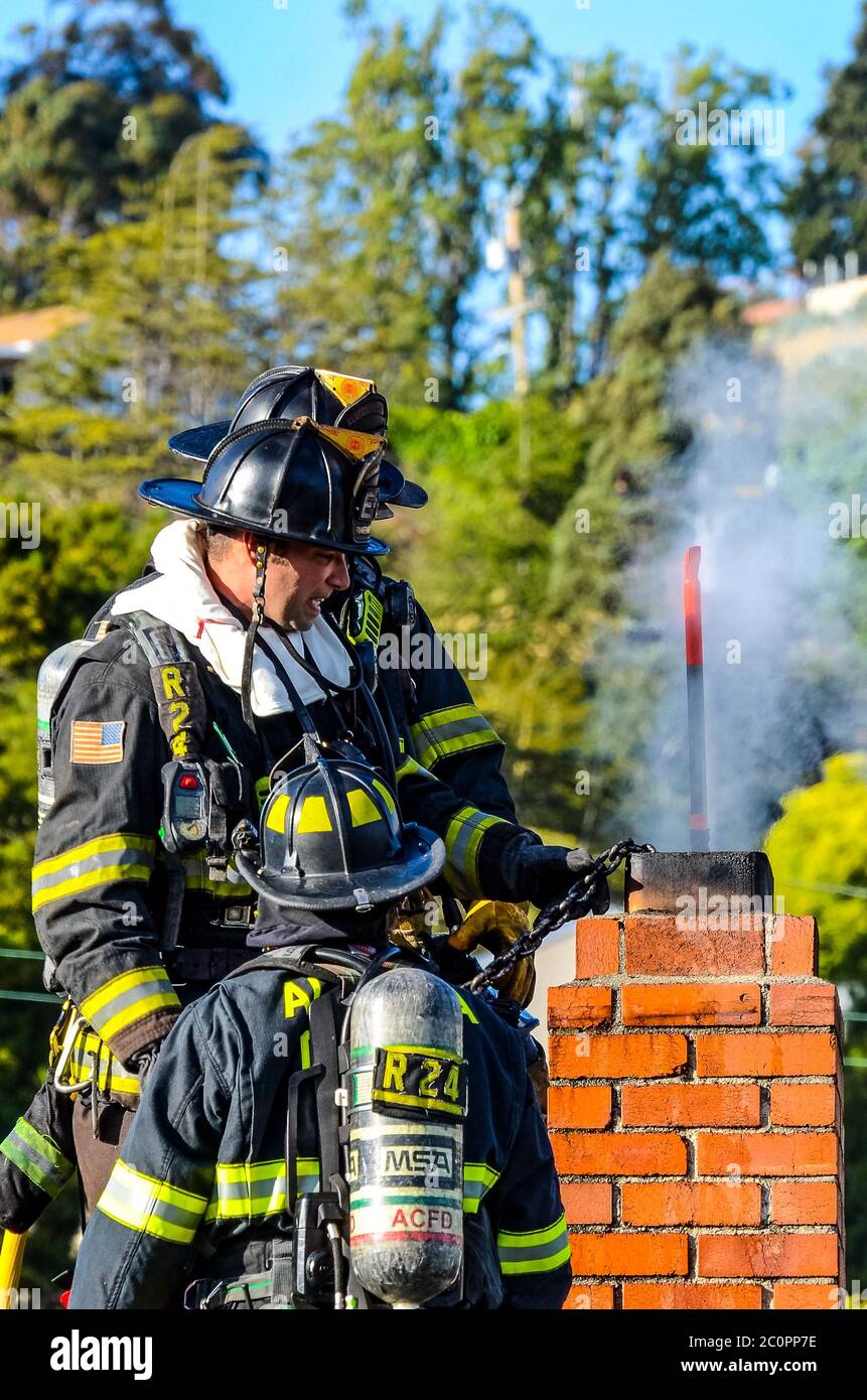 Alameda County fire department workers extinguish a chimney fire in San ...