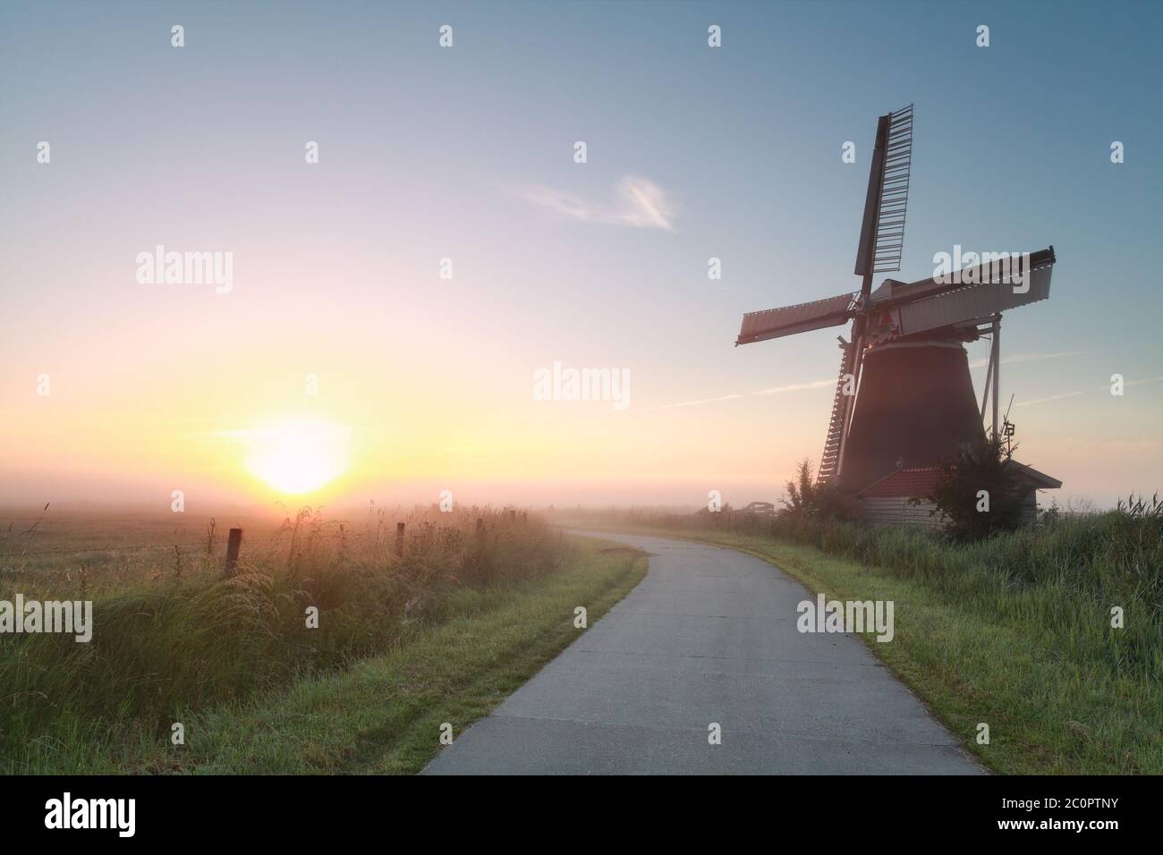 beautiful sunrise behind windmill Stock Photo - Alamy