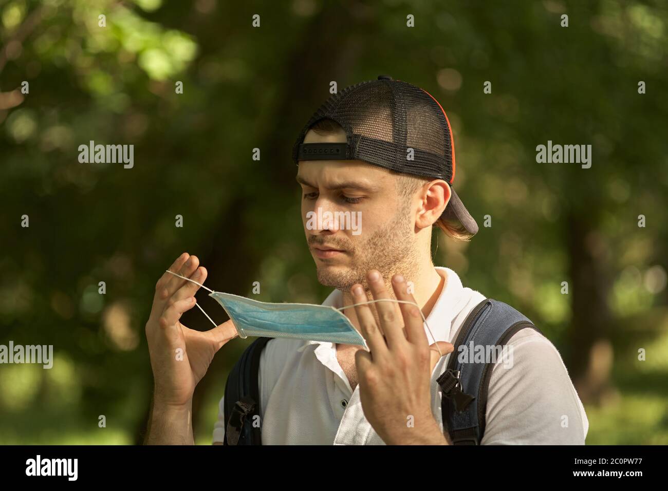 The guy takes off the mask from his face. Walk in the park Stock Photo ...