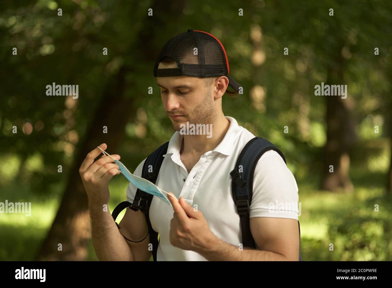 The guy takes off the mask from his face. Walk in the park Stock Photo ...