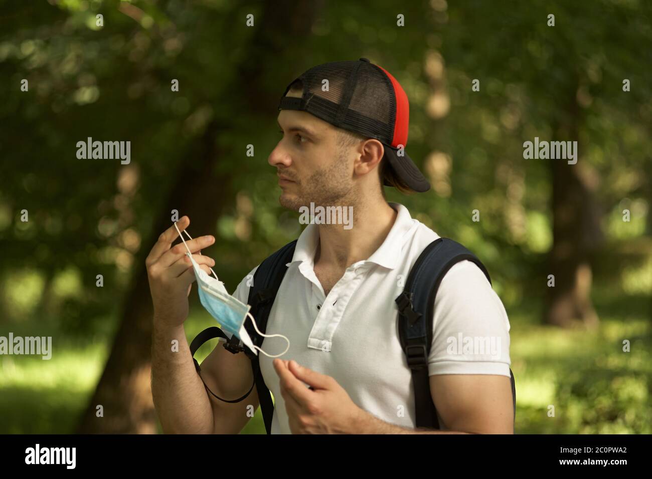 The guy takes off the mask from his face. Walk in the park Stock Photo ...