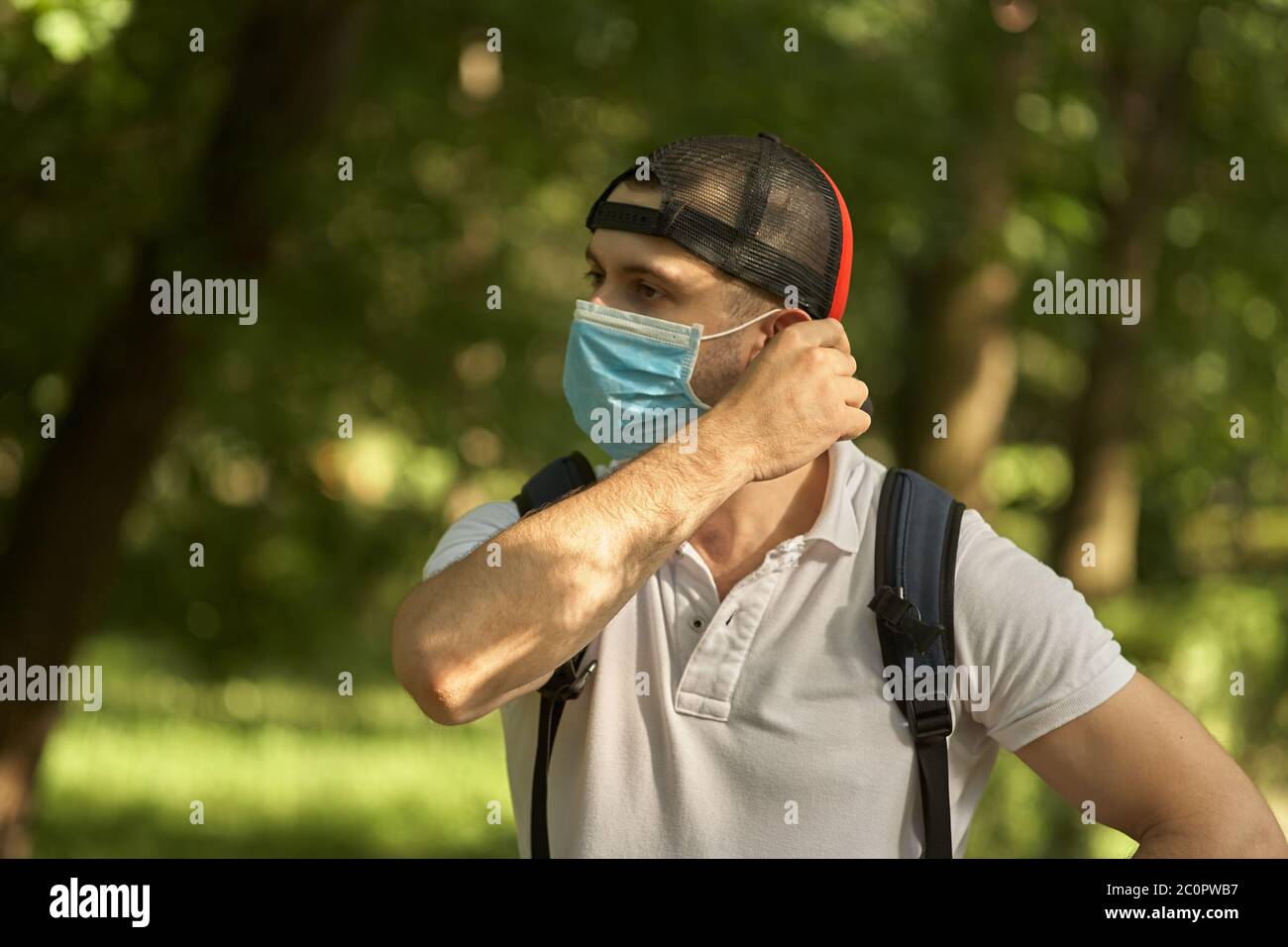 The guy takes off the mask from his face. Walk in the park Stock Photo ...