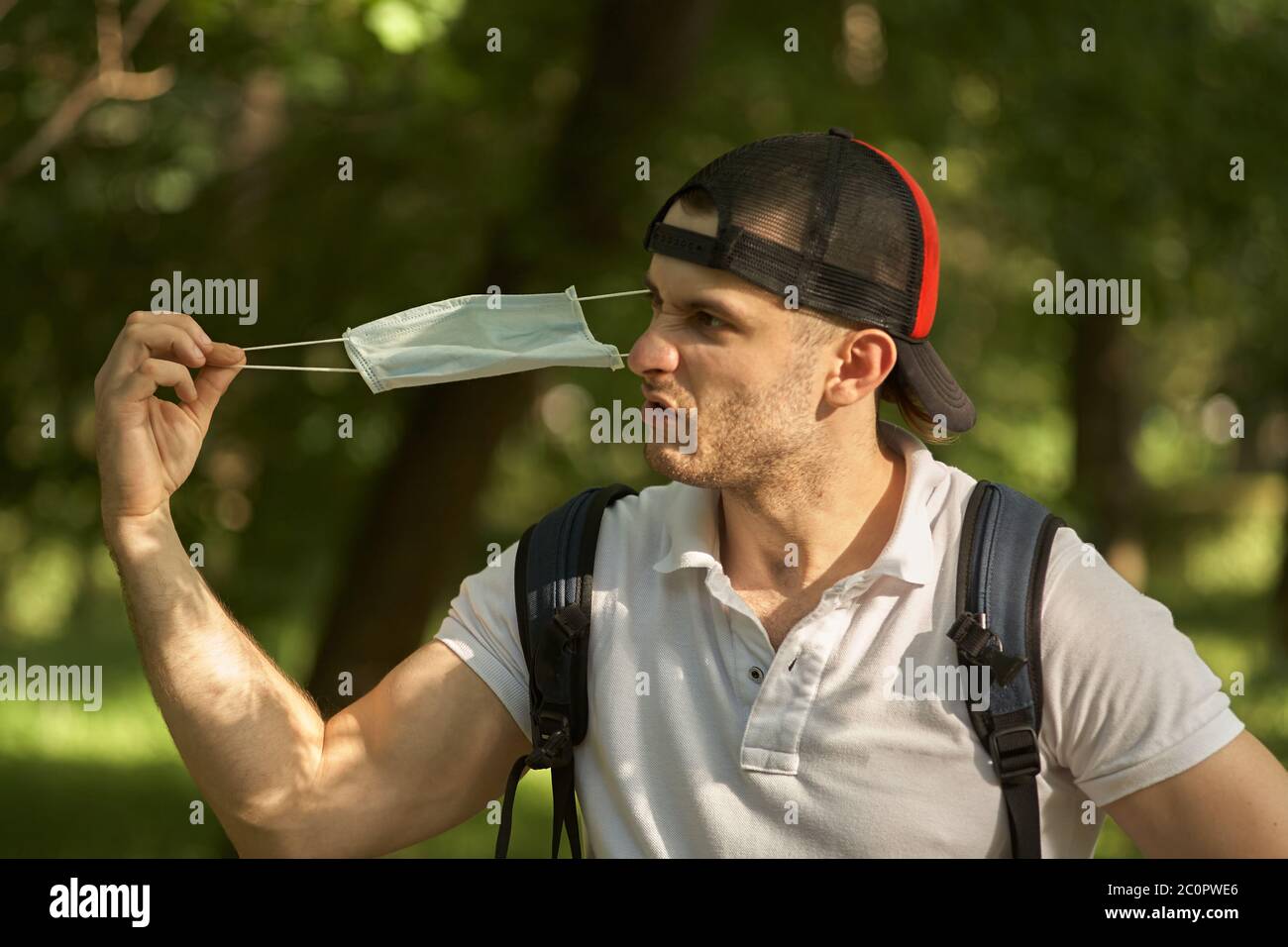 The guy takes off the mask from his face. Walk in the park Stock Photo ...