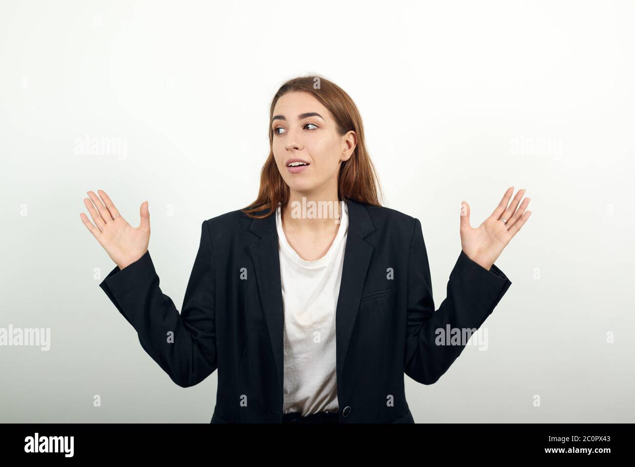 Shapes big object with two hands, gasps from surprise, holding palms in ...