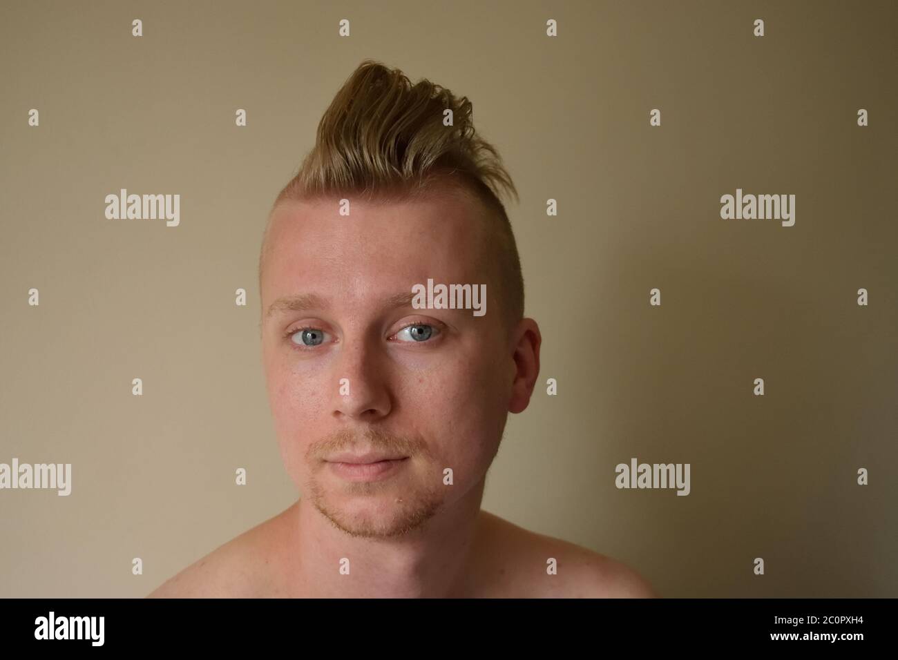 Young Man with Mohawk Hairstyle Smiling at the Camera Stock Photo - Alamy