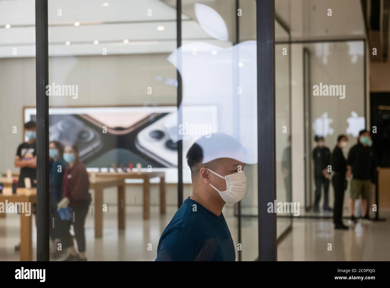 Employees stand at the entrance of the American multinational ...