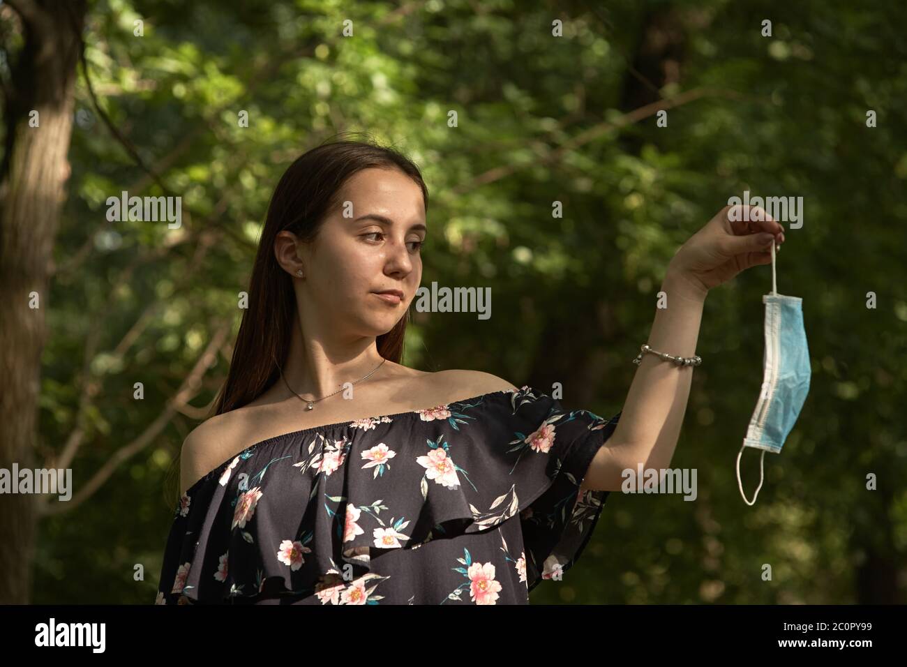 Girl resting in the park on a sunny summer day. Portrait of a woman ...