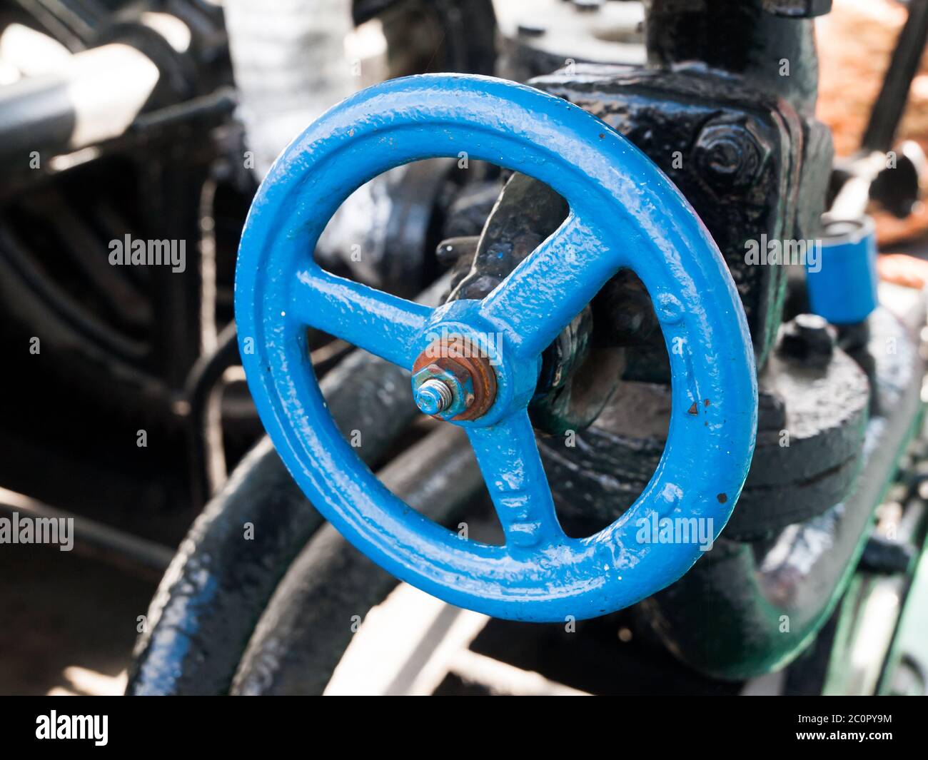 Pipes and valve with blue faucet on a ship Stock Photo - Alamy