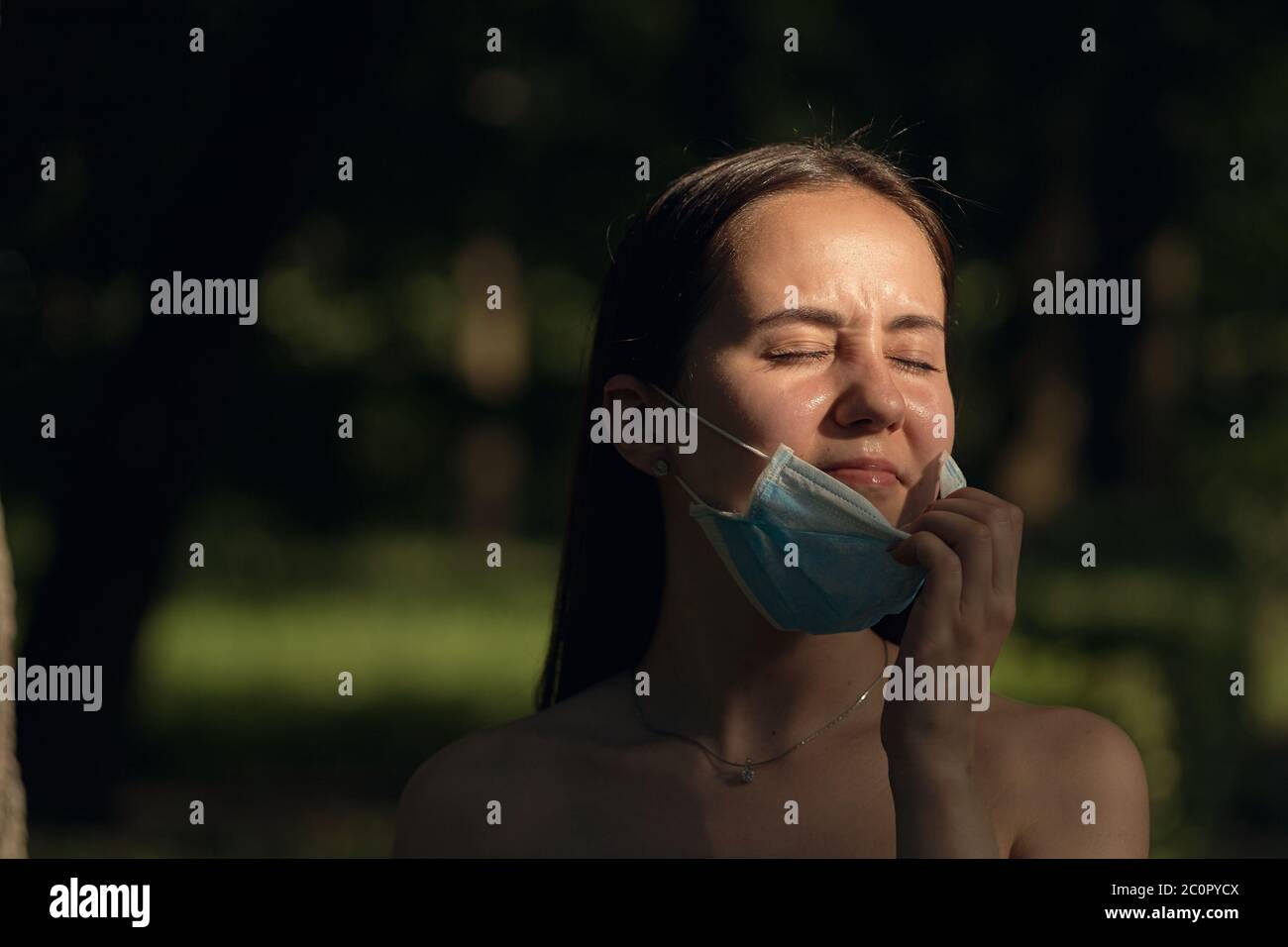 Girl resting in the park on a sunny summer day. Portrait of a woman ...