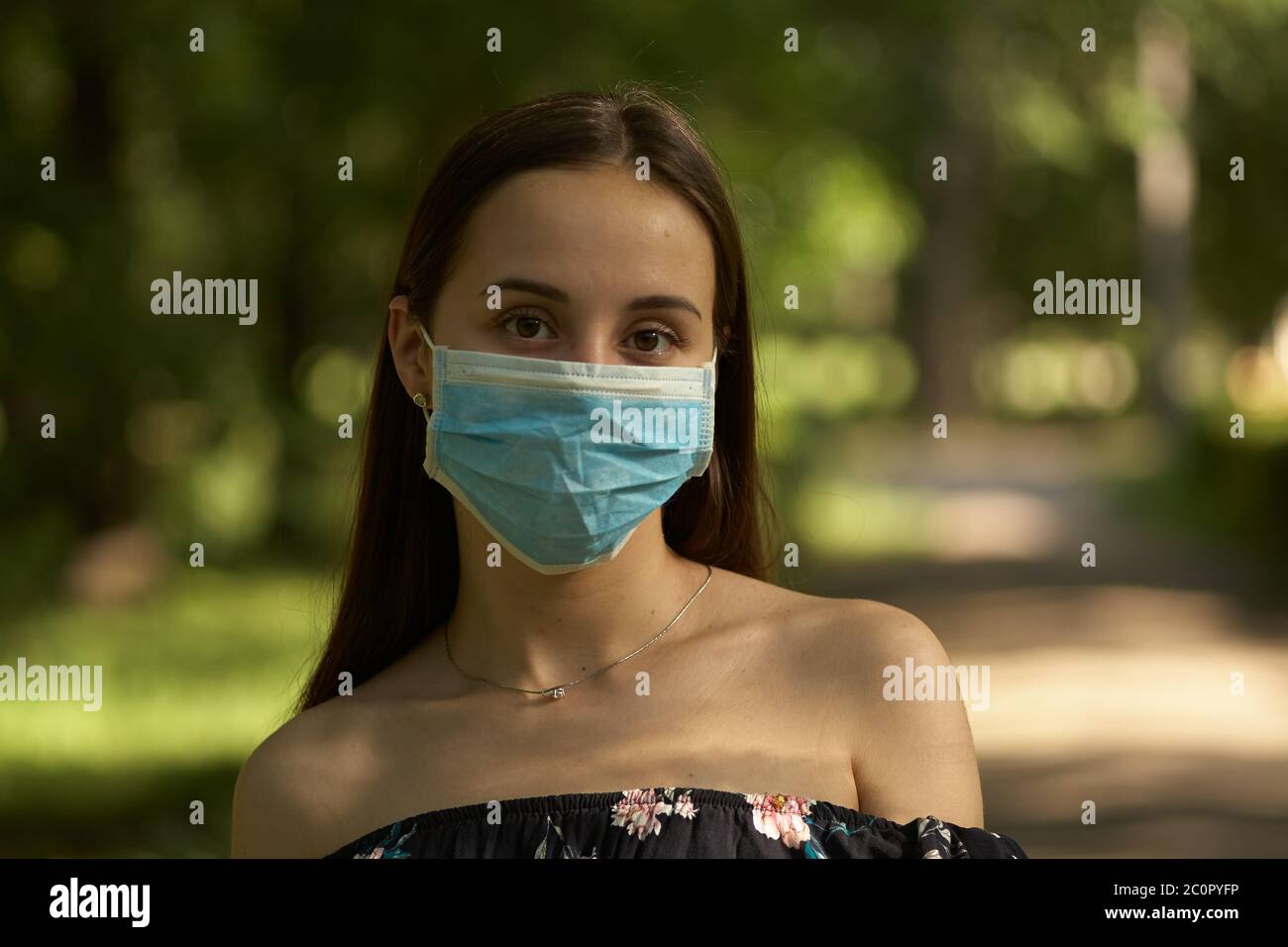 Girl resting in the park on a sunny summer day. Portrait of a woman ...