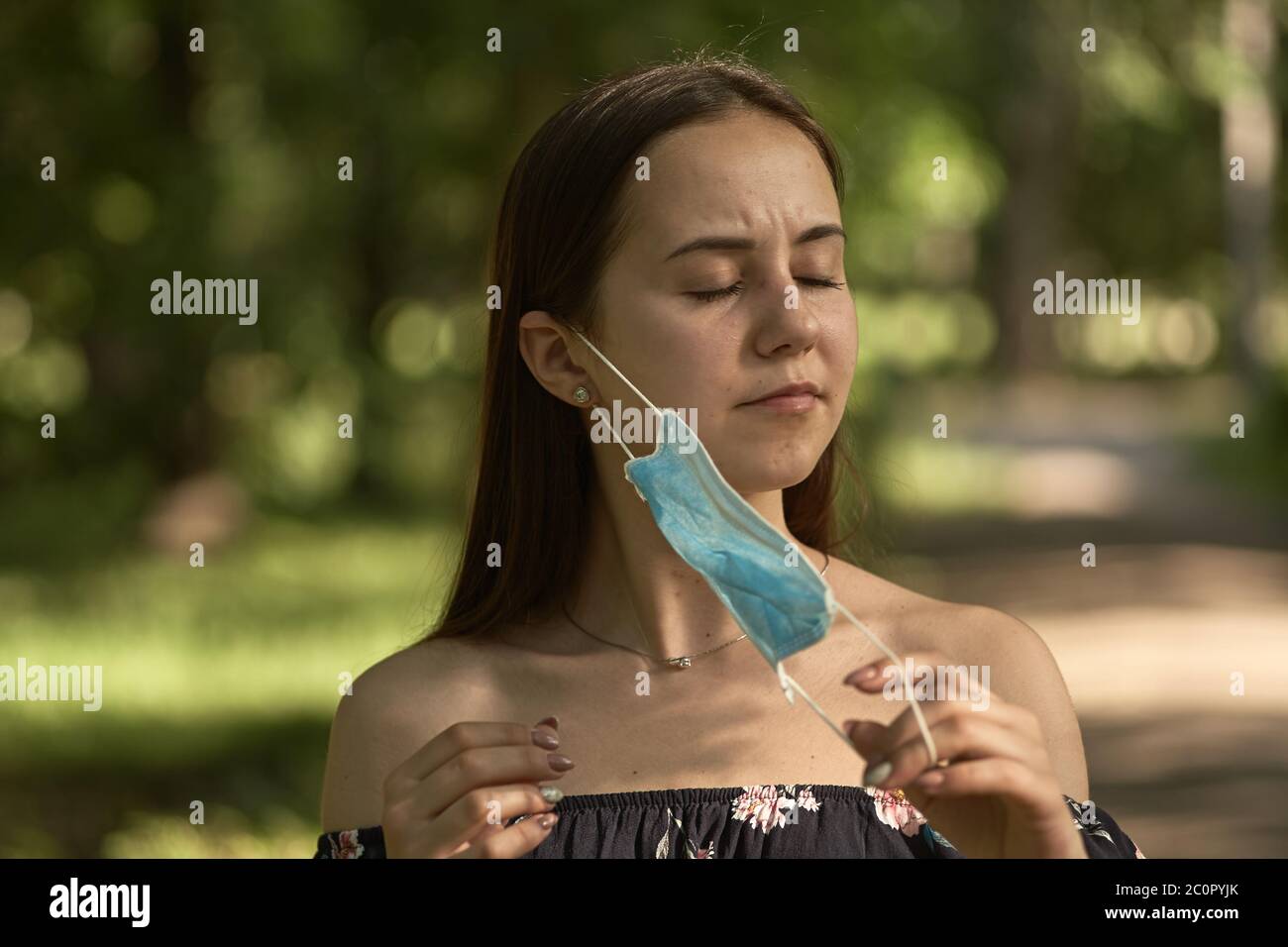 Girl resting in the park on a sunny summer day. Portrait of a woman ...