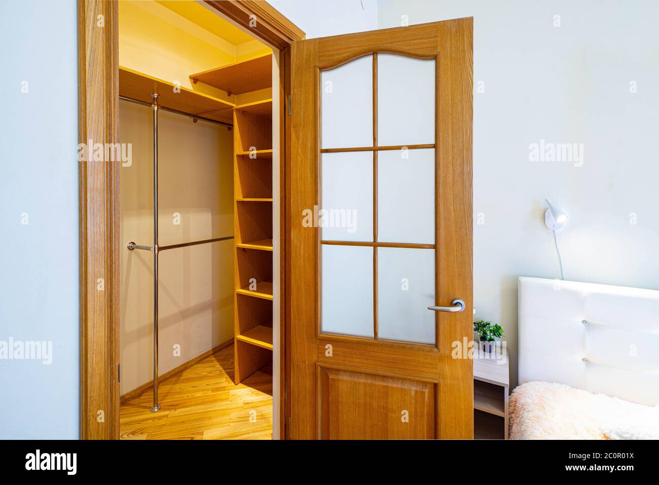 Opened door to the empty dressing room in bedroom. Modern interior of ...