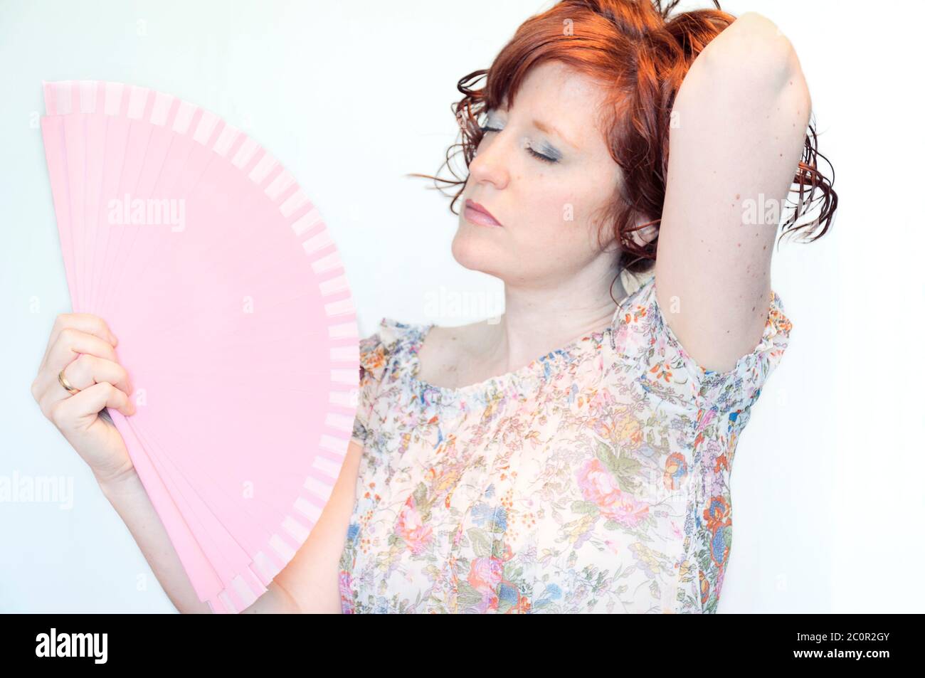 Woman fanning herself hi-res stock photography and images - Alamy