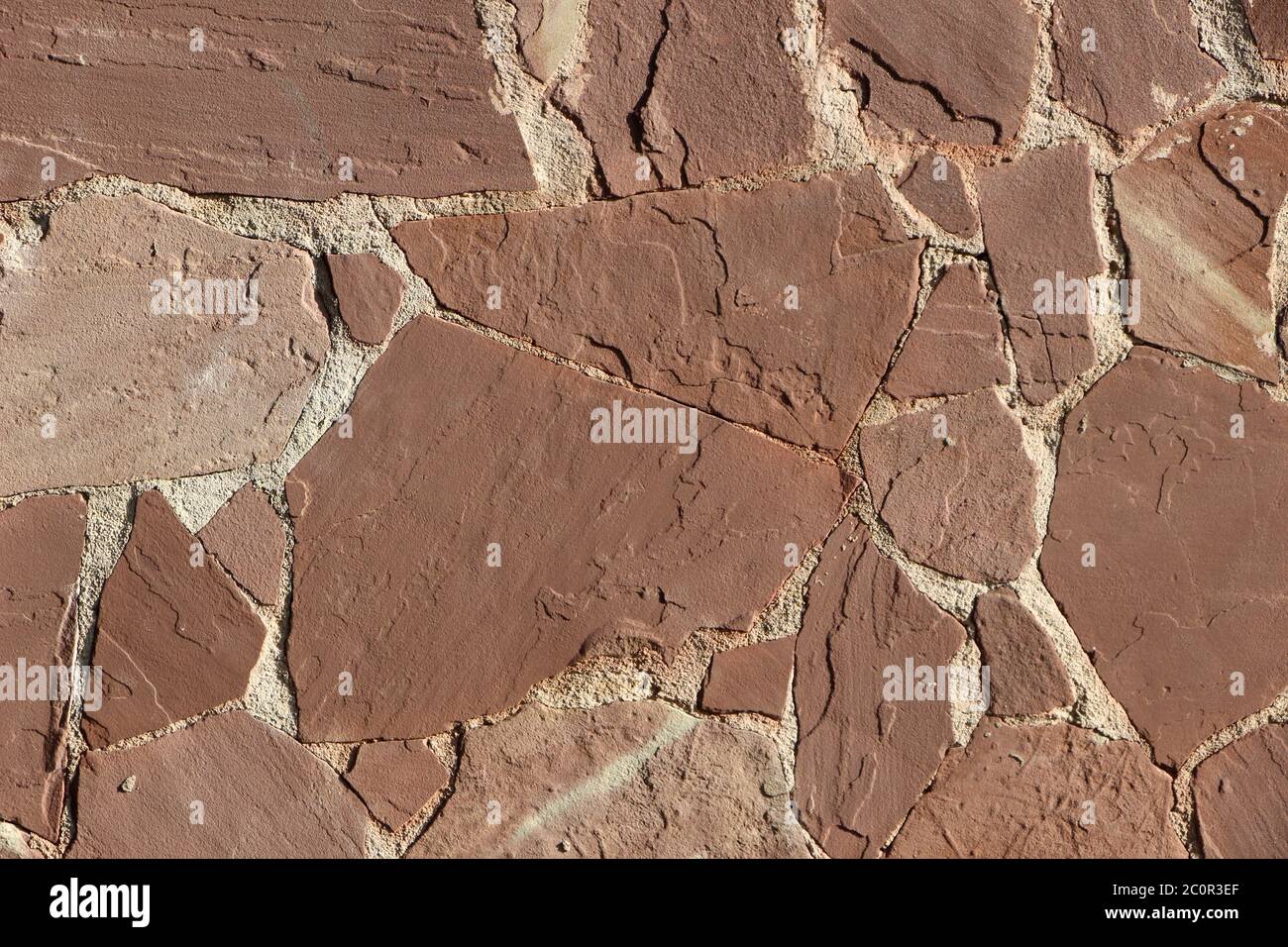 Salmon pink coloured stone wall background wallpaper sunlit Stock Photo ...
