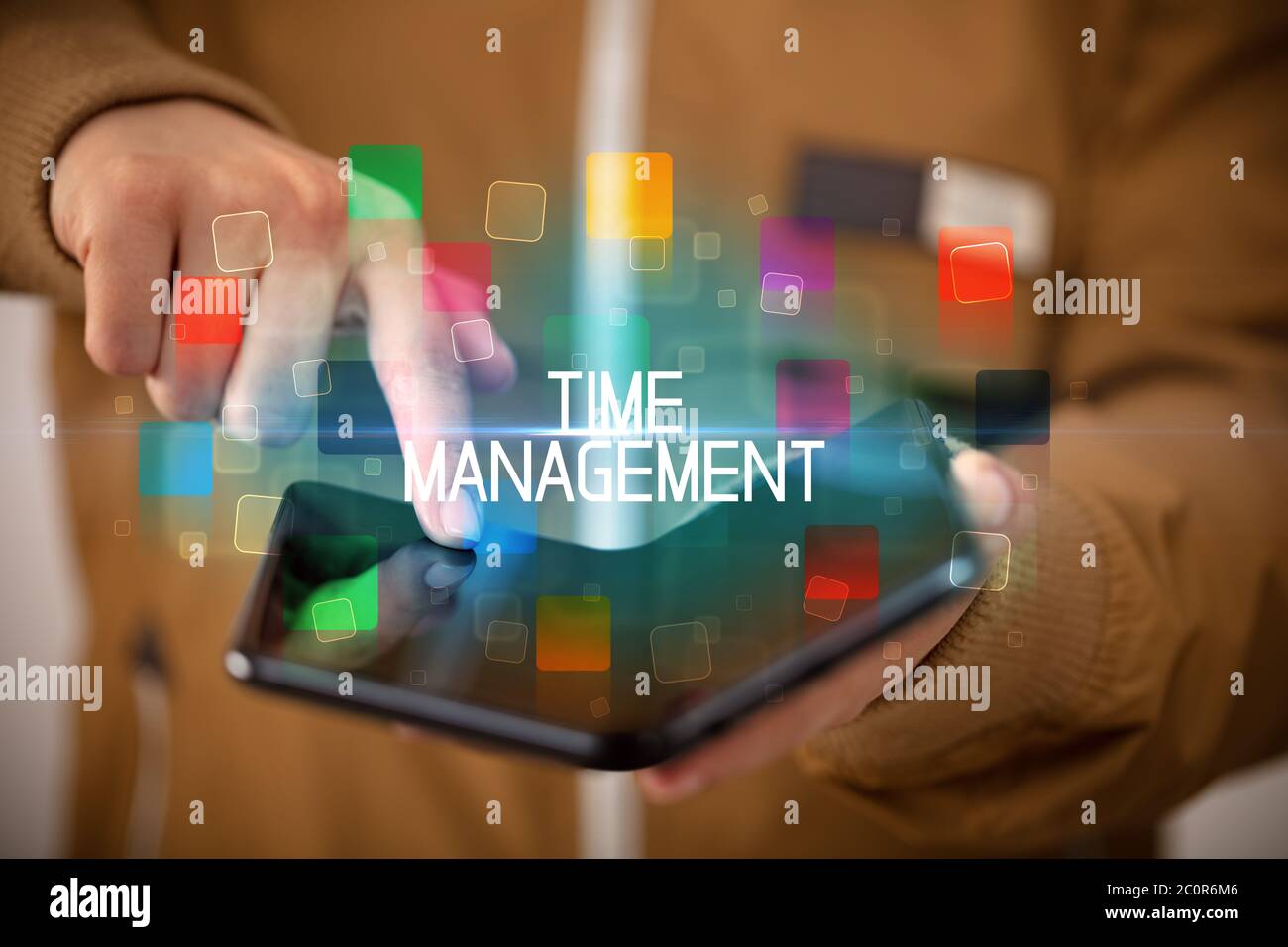 Young man holding a foldable smartphone with TIME MANAGEMENT ...