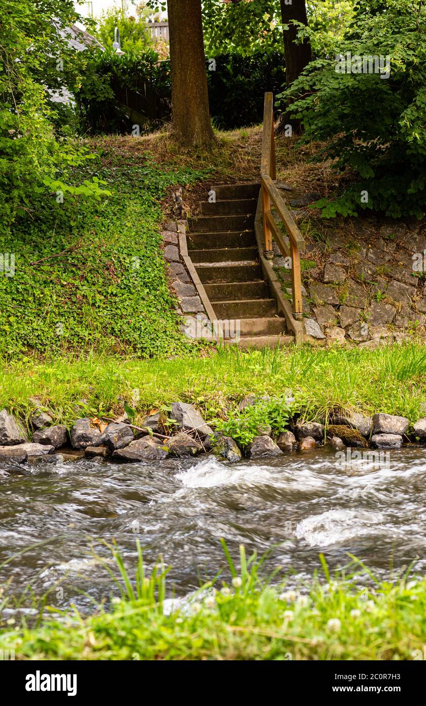 Stone stairs above the river. Recreational areas. Wooden balustrades ...
